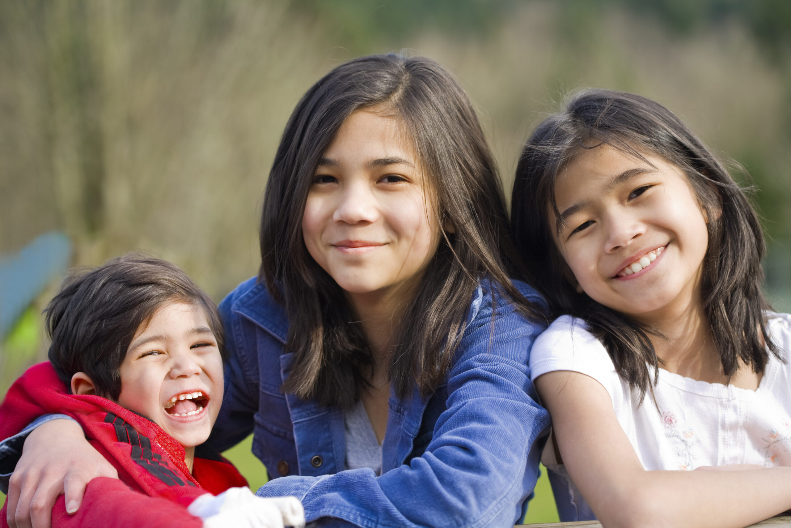 Young siblings together at a park - Realities For Children